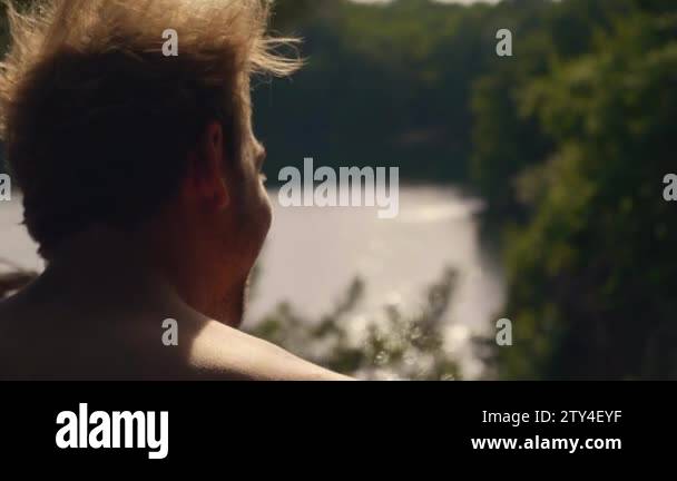 backside view on happy man looking on lake and nature in 4k Stock Video ...