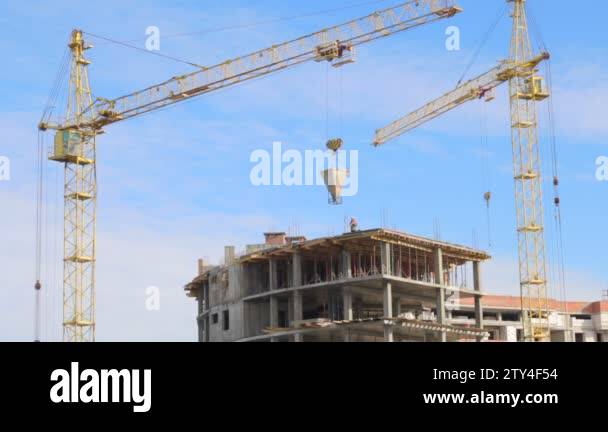 Work tower crane at the construction site. The crane moves the concrete ...