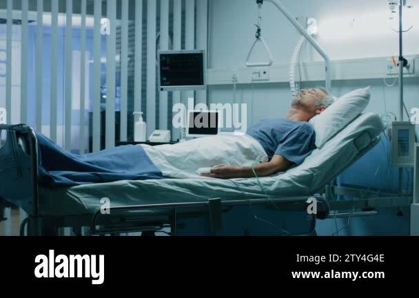 In the Hospital Sick Man Rests, Lying on the Bed. Recovering Man ...