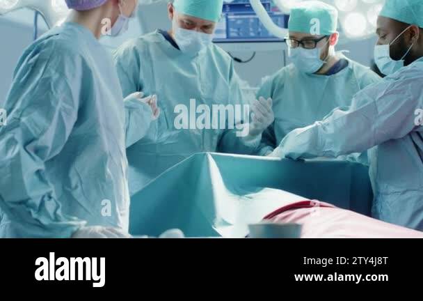 Diverse Team of Professional surgeon, Assistants and Nurses Performing ...