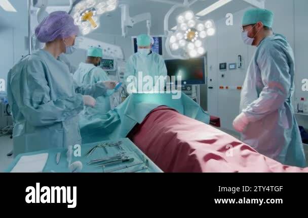 Diverse Team of Professional Surgeons Performing Invasive Surgery on a ...