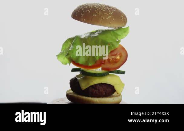 Composition of a large burger, the ingredients individually hang in the ...