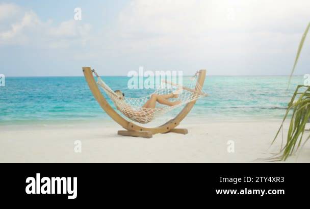 Idyllic Scene. Beautiful Woman Sunbathing Lying in Hammock on a Beach ...