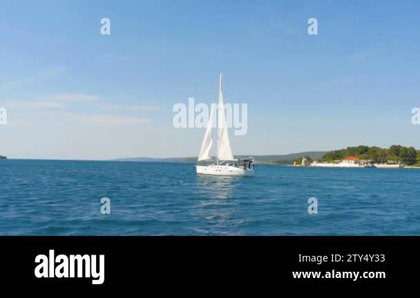 Sailing boat far away filmed from moving sailing boat in Adriatic sea ...