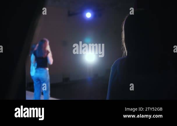 A theater stage. A performance. Two girls acting on the stage and third ...