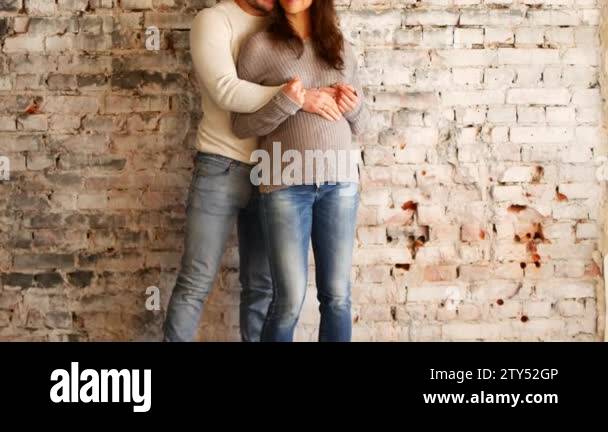 Mom and dad hands on pregnant tummy showing heart sign. Pregnant couple ...