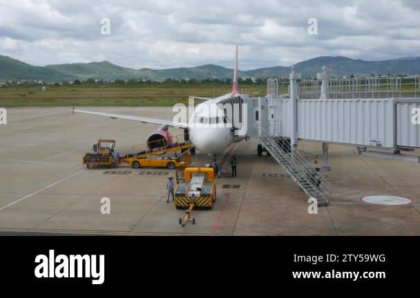 Airplane boarding and loading cargo containers. DALAT, VIETNAM ...