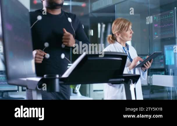 Monitor Shows EKG Reading of a Male Athlete Running on a Treadmill in ...