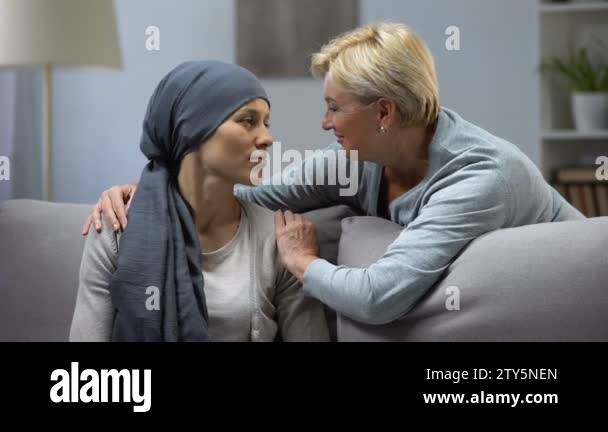 Mother hugging and kissing her hopeless daughter with cancer, family ...