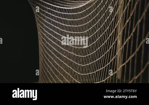 Football is flying into the gate net in the black background in slow ...