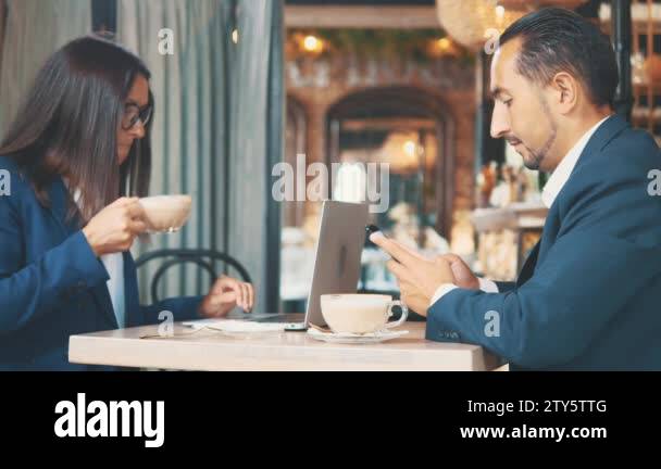 Two business people have business lunch. The woman and the man in a ... Two business people have business lunch. The woman and the man in a ...