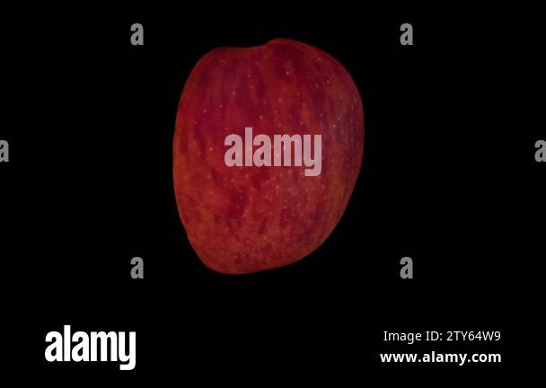Realistic render of a rotating half Red Delicious apple on black ...