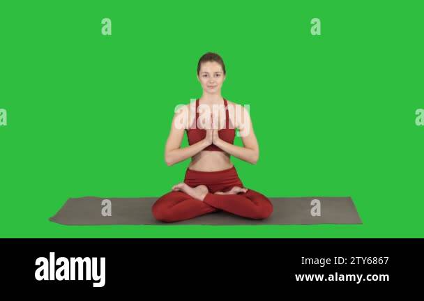 Beautiful young woman sitting in yoga pose Lotus changing position of ...