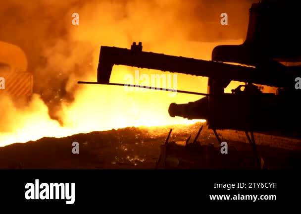 Molten metal pouring from the special mechanism, metallurgy concept ...