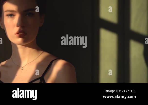 Beautiful woman with dark short hair, wearing a black bra standing ...