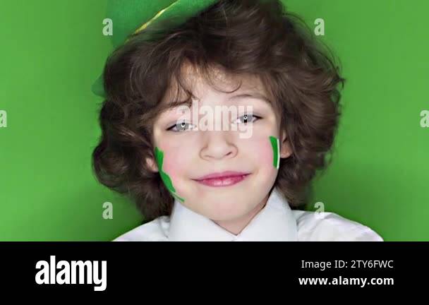 Child Celebrating St. Patrick's Day looking at the camera. A small ...