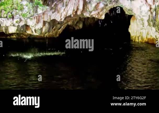 Spring water drips from the roof of a limestone underground river cave ...