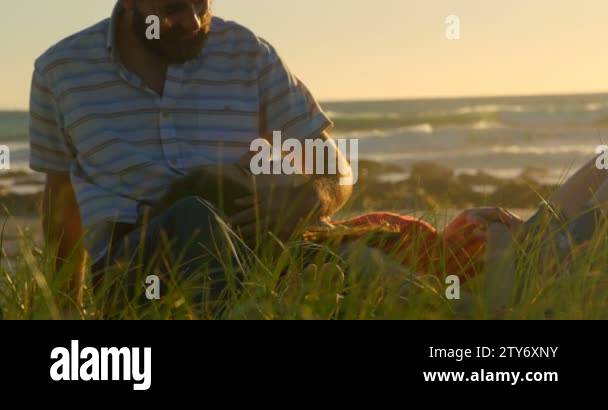 Young man caressing womans hair while lying on mans lap. Couple ...