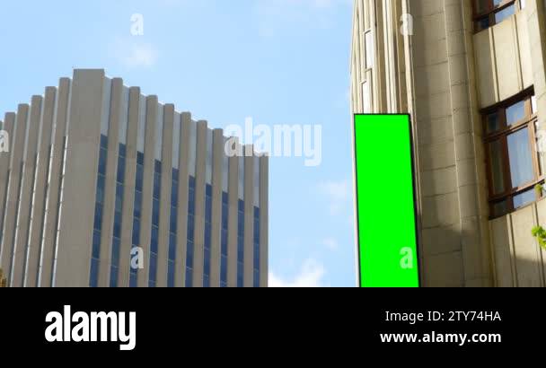 Led hoarding on the exterior of the building in city. Green screen ...