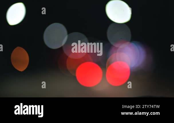 Colored bokeh lights in the night country road. moving circles of ...