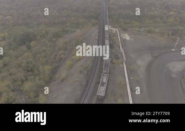 Freight train rides along the beautiful nature. The cars are empty ...