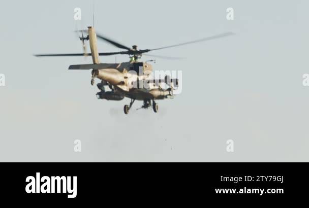 AH-64D Apache Longbow military helicopter attacking targets with canon ...