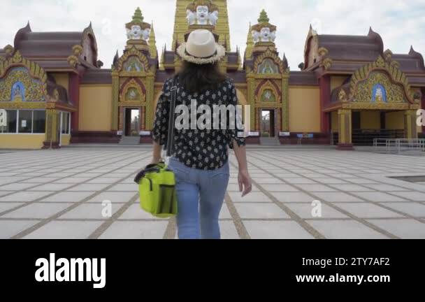 Asian woman tourist walking in the buddhist temple and admire to see a ...
