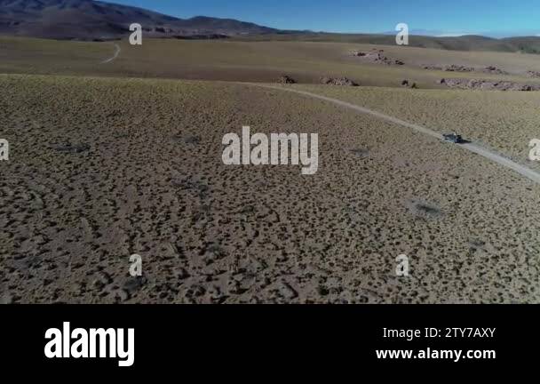 Aerial drone scene of 4x4 van driving at track off road at golden ...