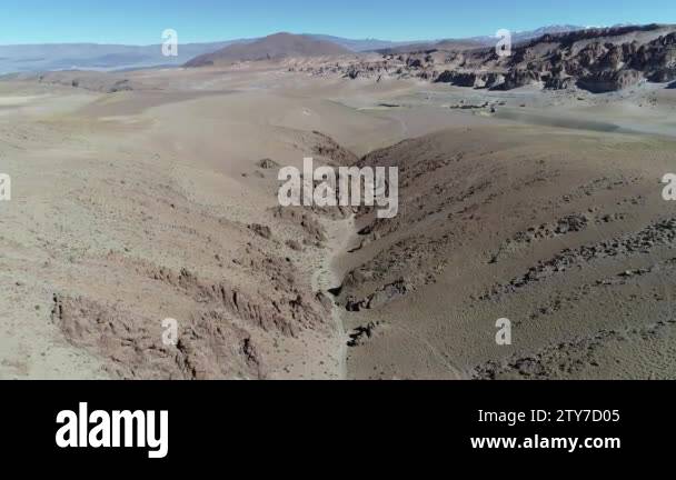Aerial drone scene of narrow orange canyon at high golden plateau ...