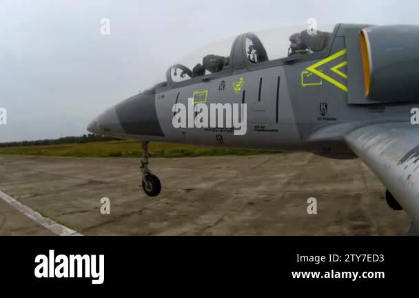 A training gray blue fighter plane go down on the landing strip or ...