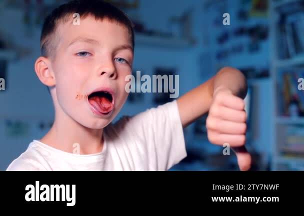 child shows tongue, like hand, forehead sit down fly Stock Video ...