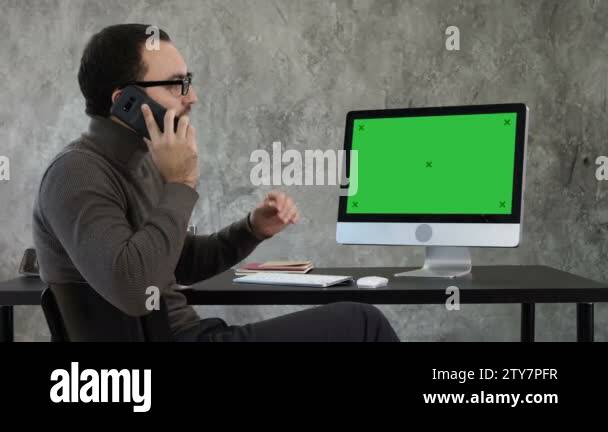 Architect talking on the phone discussing the project on the screen of ...