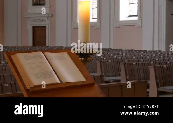 Inside an empty catholic church. Wooden pews for church members and the ...