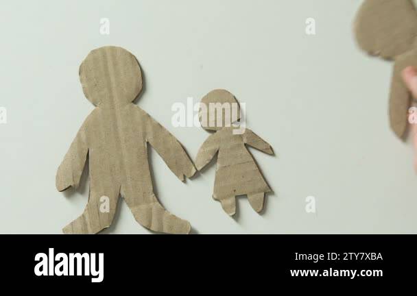 Kid adding figure of mother and toy heart to paper family dreaming ... Kid adding figure of mother and toy heart to paper family dreaming ...