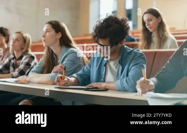 Hispanic Young Man Among His Fellow Students in the Classroom. Young ...