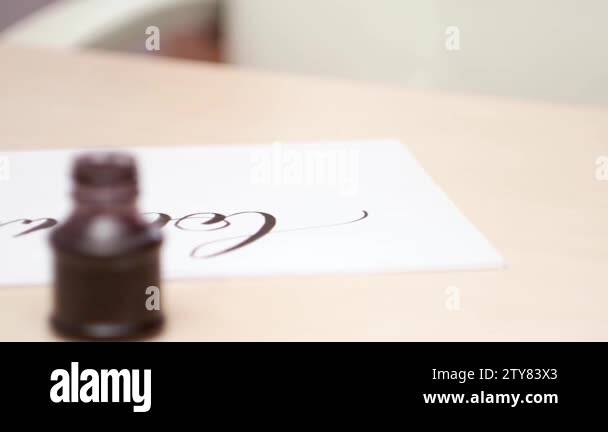 Calligraphic tools on beige table. Close shot. Side view. Camera moves ...