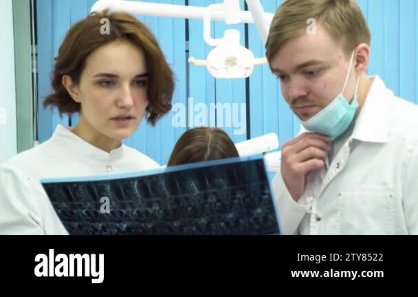 Dentists man and woman looking at full body x-ray radiographic image ...