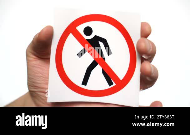 No pedestrian traffic prohibited allowed sign isolated. Male hand ...
