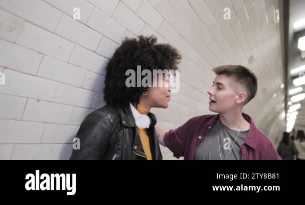 Millennial friends talking in an underground station Stock Video ...