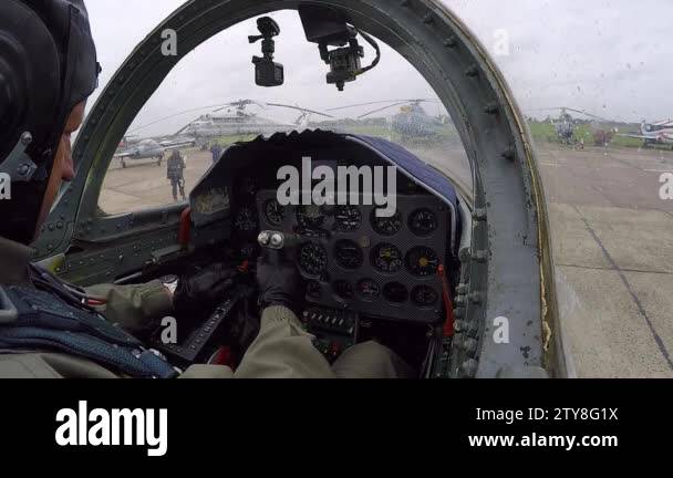 The pilot of gray training fighter plane wipes and cleans the ...