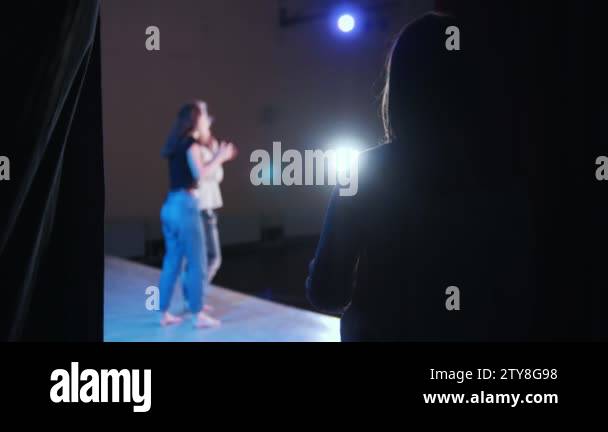 A theater stage. A repetition of performance. Two girls acting on the ...