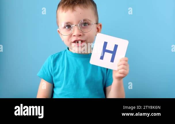 Cute little boy with letter on blue background. Child learning a ...
