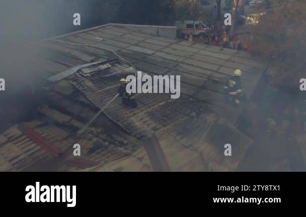 fire industrial building and fog smoke fireman shooting from a height ...