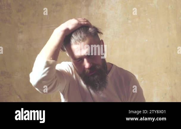 Bearded man washing face in morning. Man spraying water on his face ...