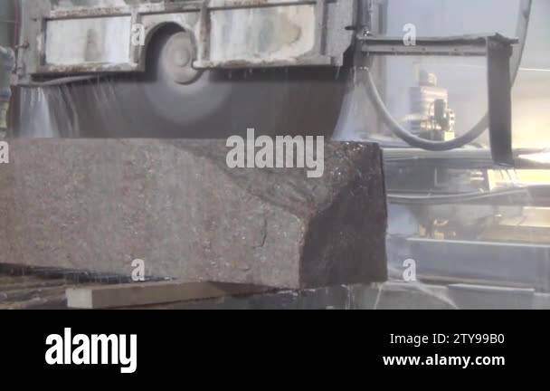 Granite processing in manufacturing. Cutting granite slab with a ...