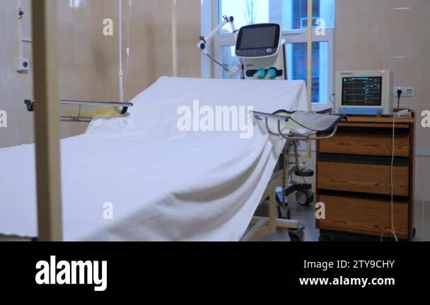 Postoperative ward in the clinic. White sheet on the hospital bed in ...