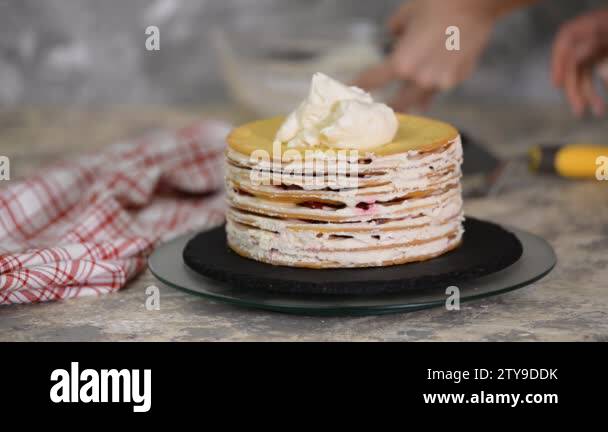 The process of making a cake. Chef making layer cake with cherry ...