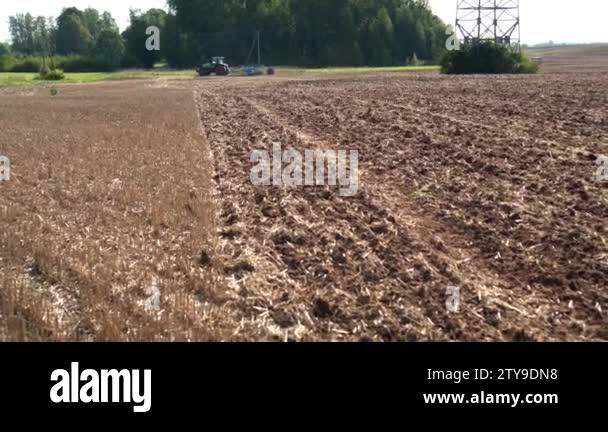 Tractor discing stubble field. Agricultural machine cultivating farm ...