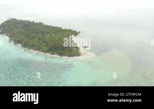 Aerial: Flying over idyllic atoll, travel destination Wakatobi National ...
