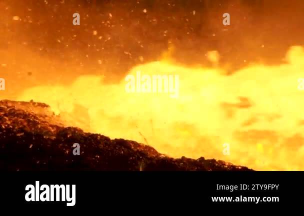 Close up for liquid metal flowing from blast furnace at the ...